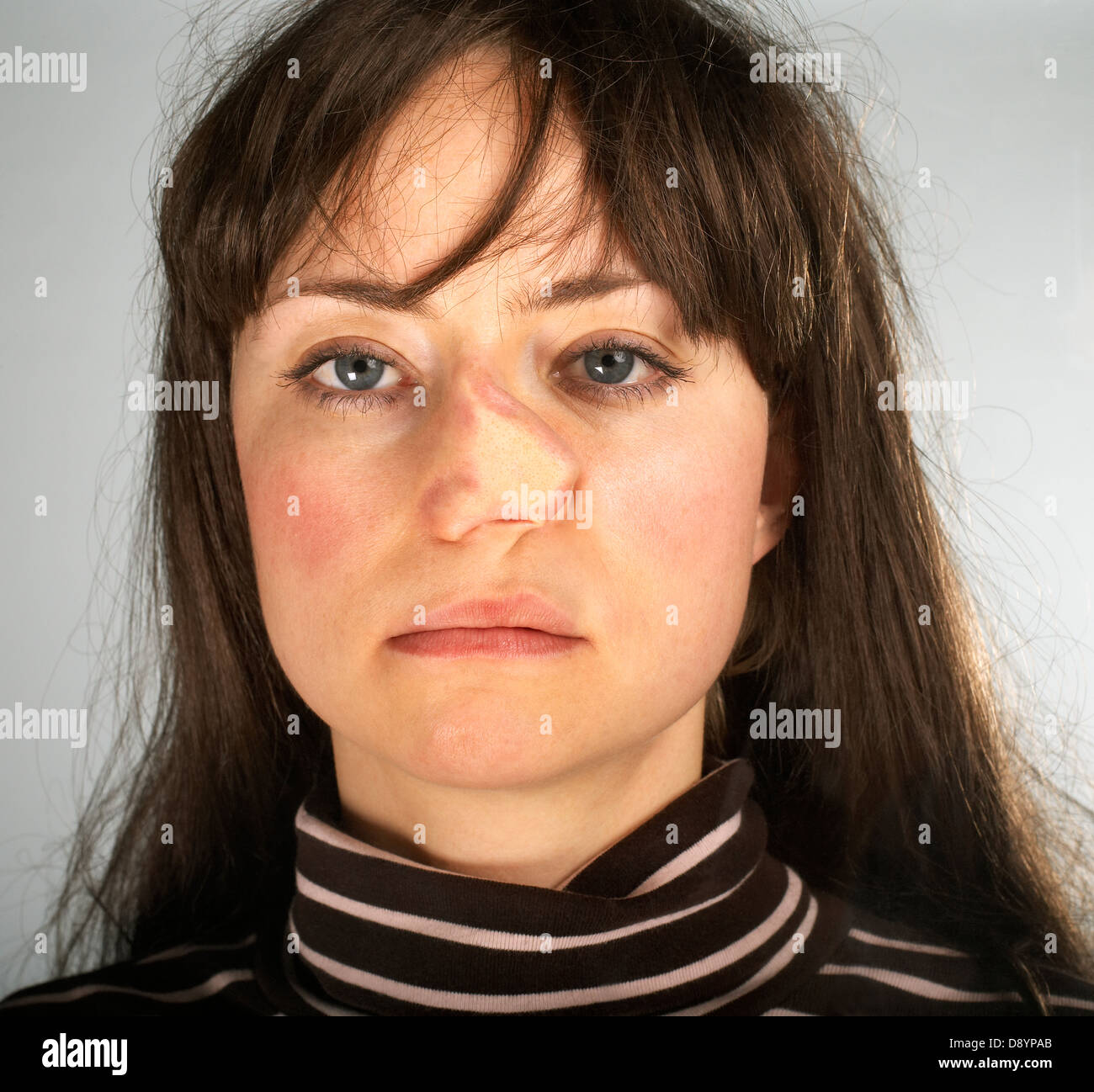 A woman pressing her nose against a pane of glass Stock Photo - Alamy