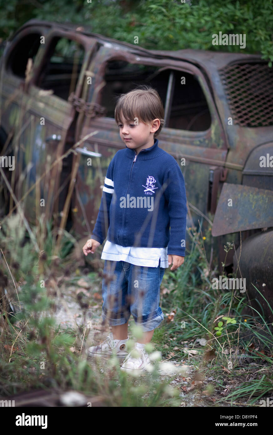 Boy standing in front of old car Stock Photo - Alamy