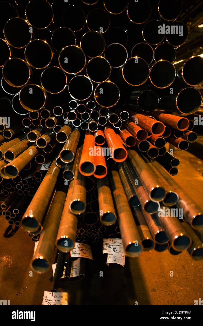Stack of steel pipes in factory Stock Photo - Alamy
