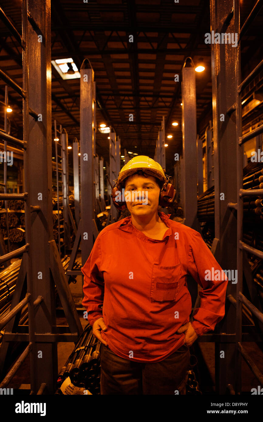 Woman wearing protective workwear standing in factory Stock Photo - Alamy