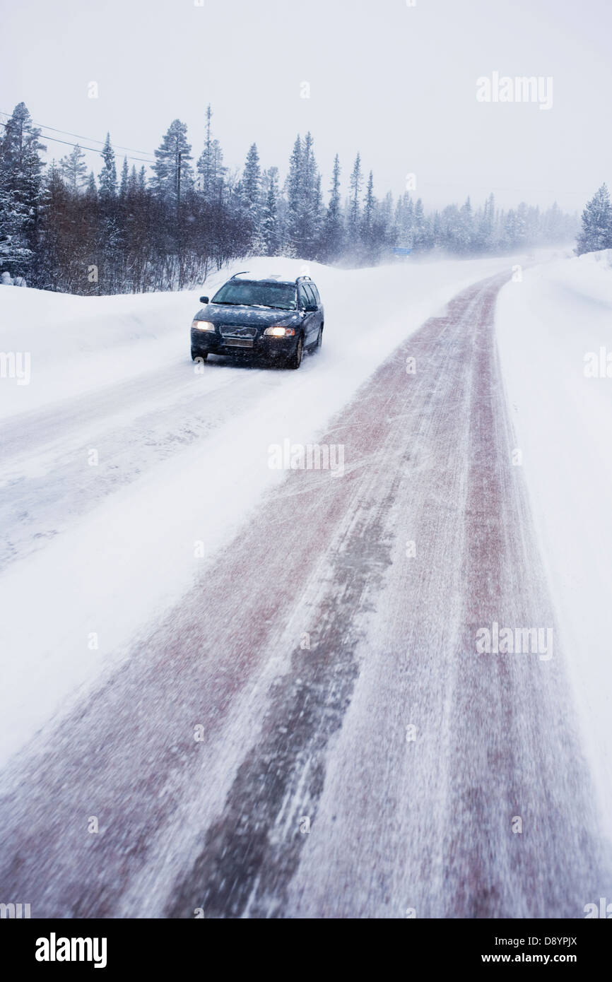 Car on snow covered road Stock Photo - Alamy