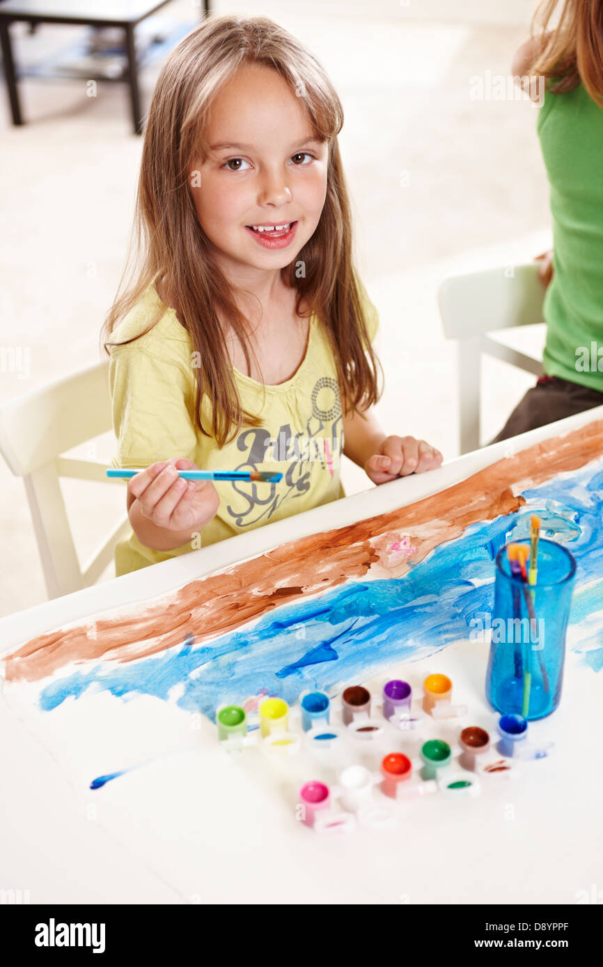 Girl painting with watercolour paints Stock Photo - Alamy