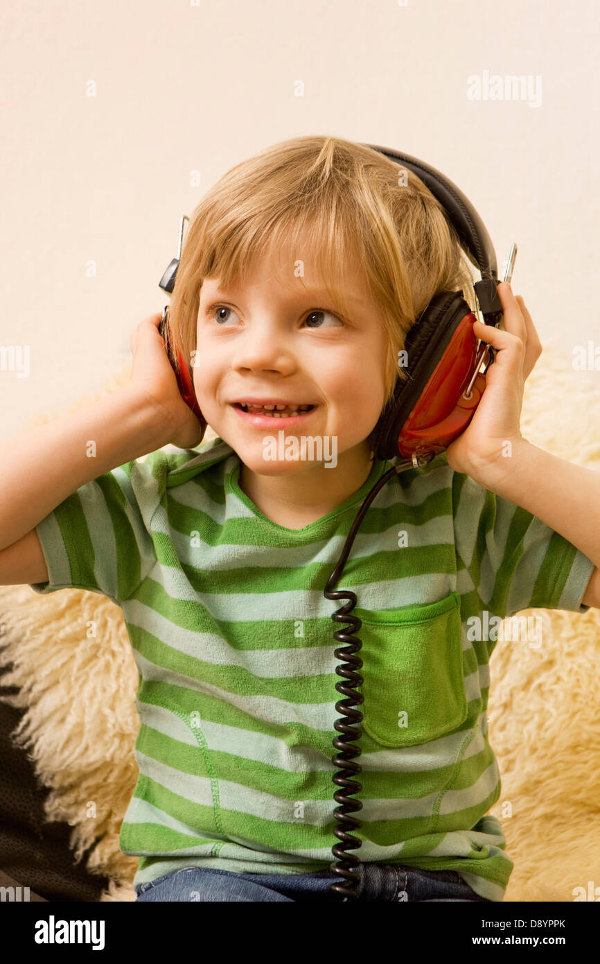 Boy listening music through headphone Stock Photo - Alamy