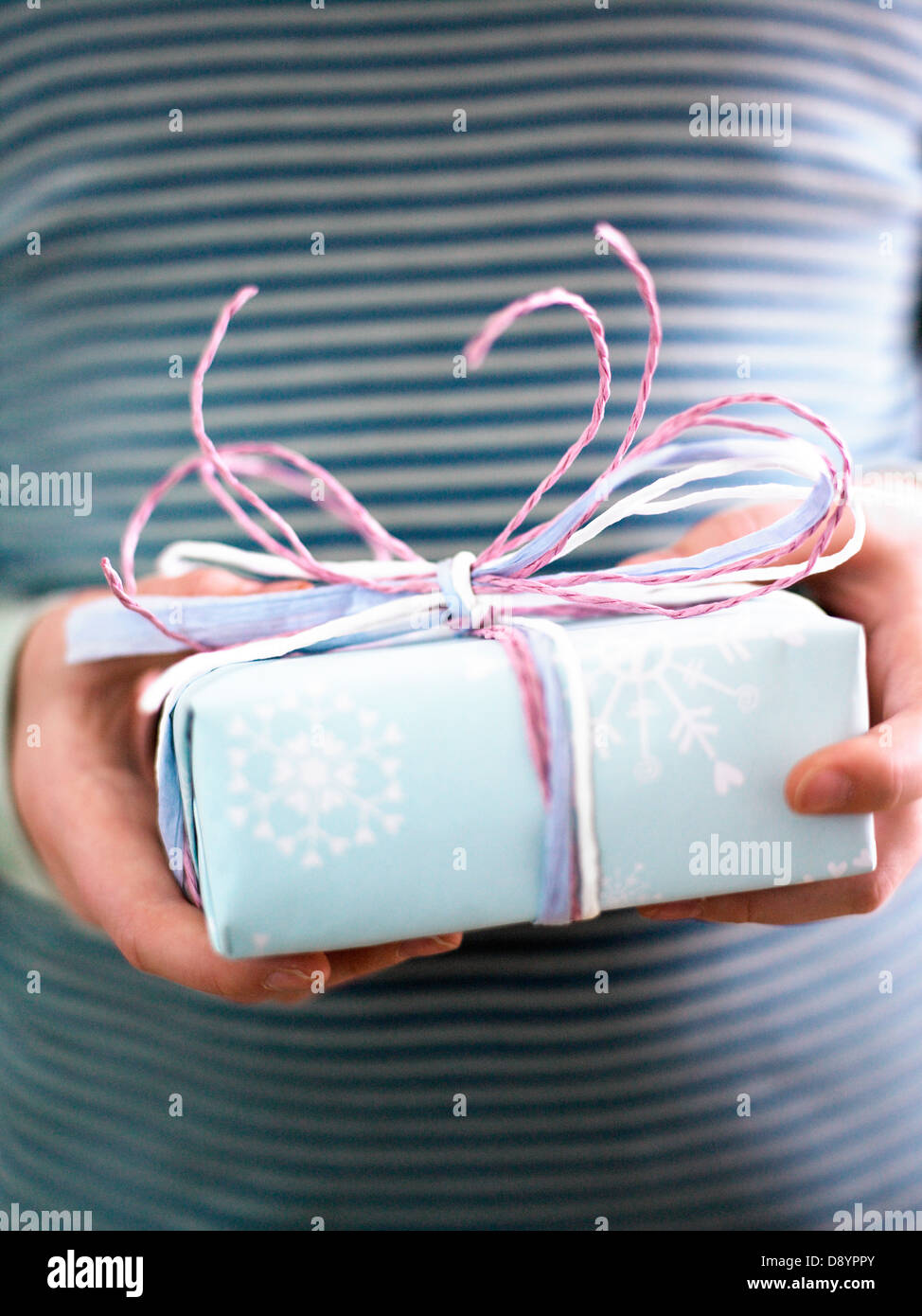 Two hands holding a parcel Stock Photo - Alamy