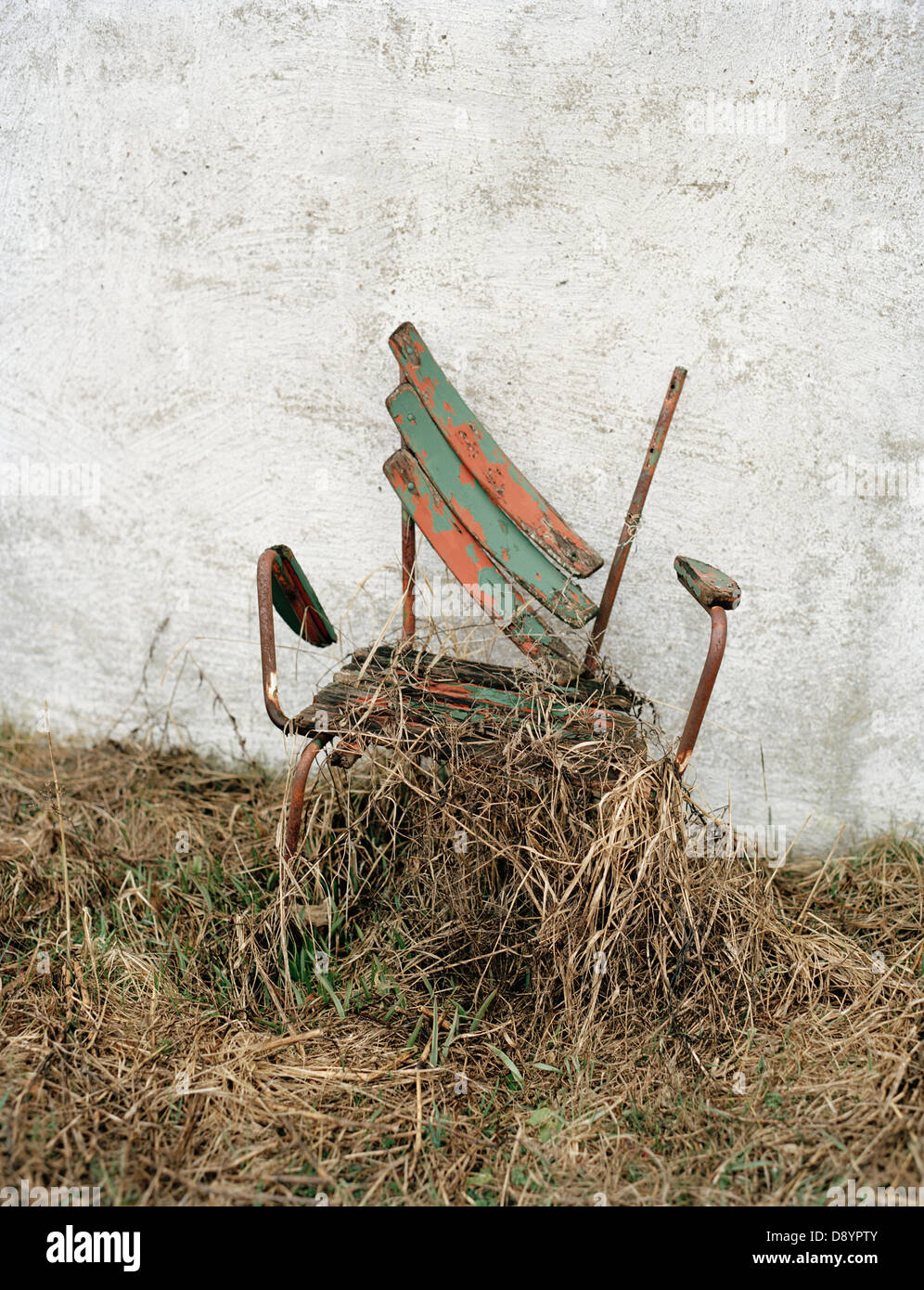 A broken chair by a house wall Stock Photo - Alamy