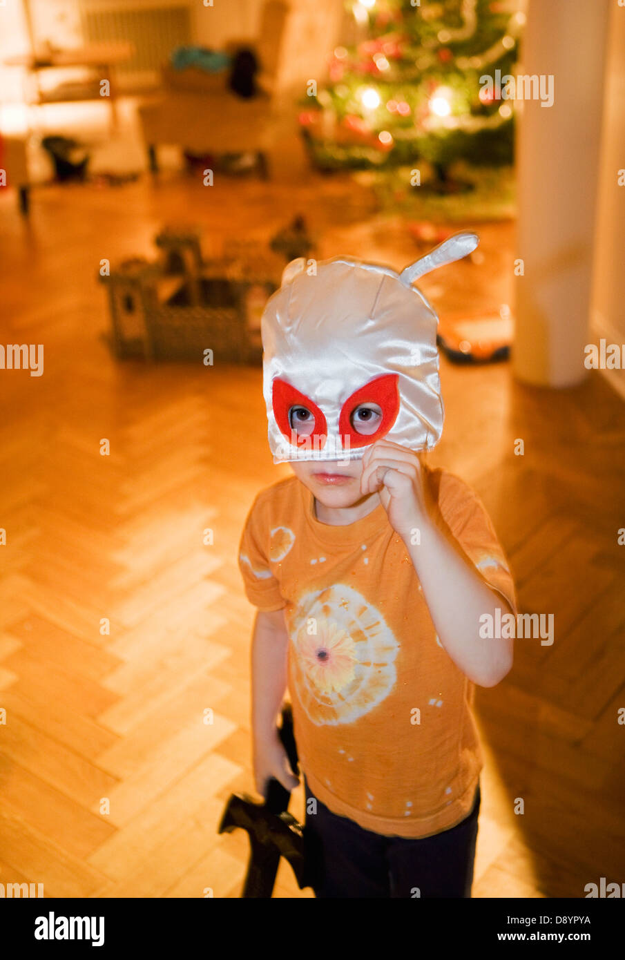 Boy wearing mask on christmas eve Stock Photo - Alamy