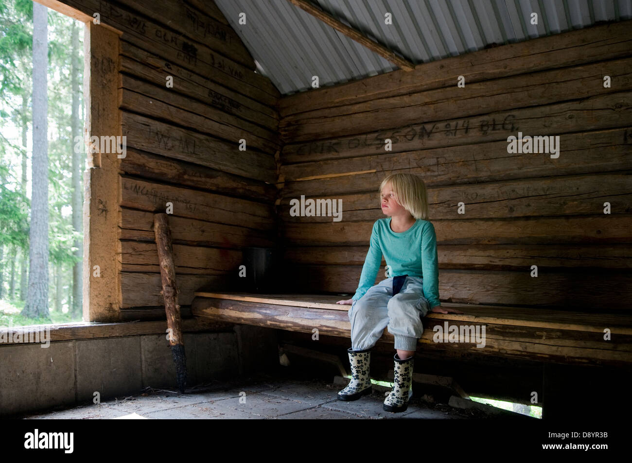 Girl sitting in cottage Stock Photo - Alamy