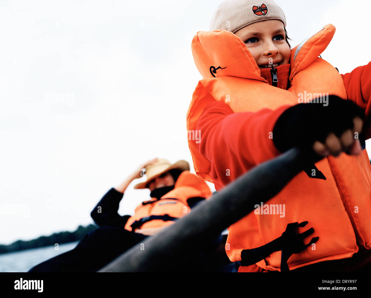 Boy rowing with his mother in a boat Stock Photo - Alamy
