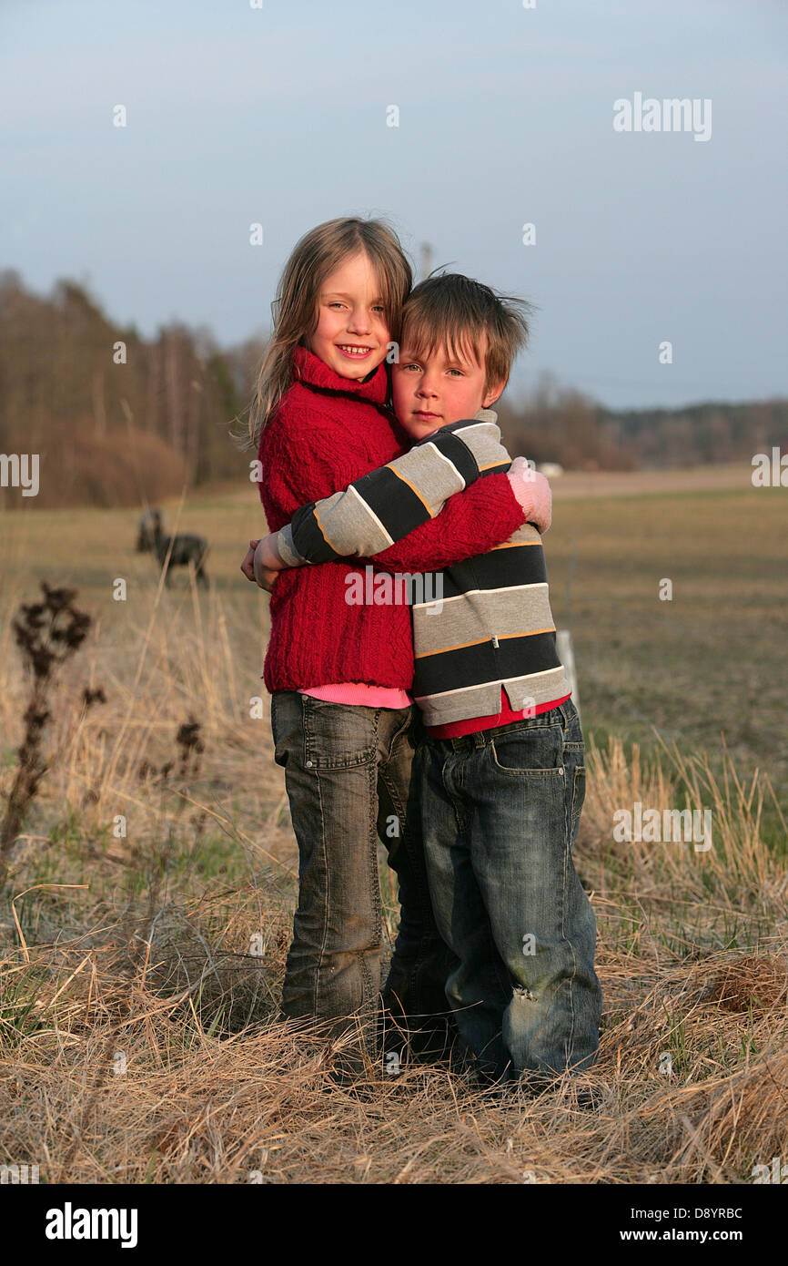 A brother and a sister hugging each other Stock Photo - Alamy