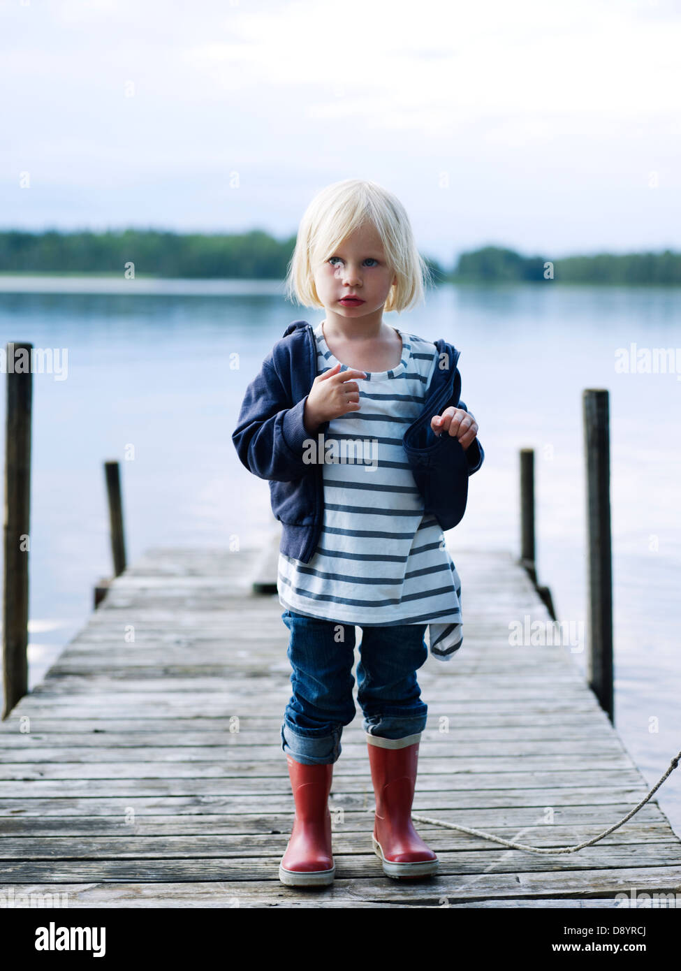 Portrait of girl standing on jetty Stock Photo - Alamy