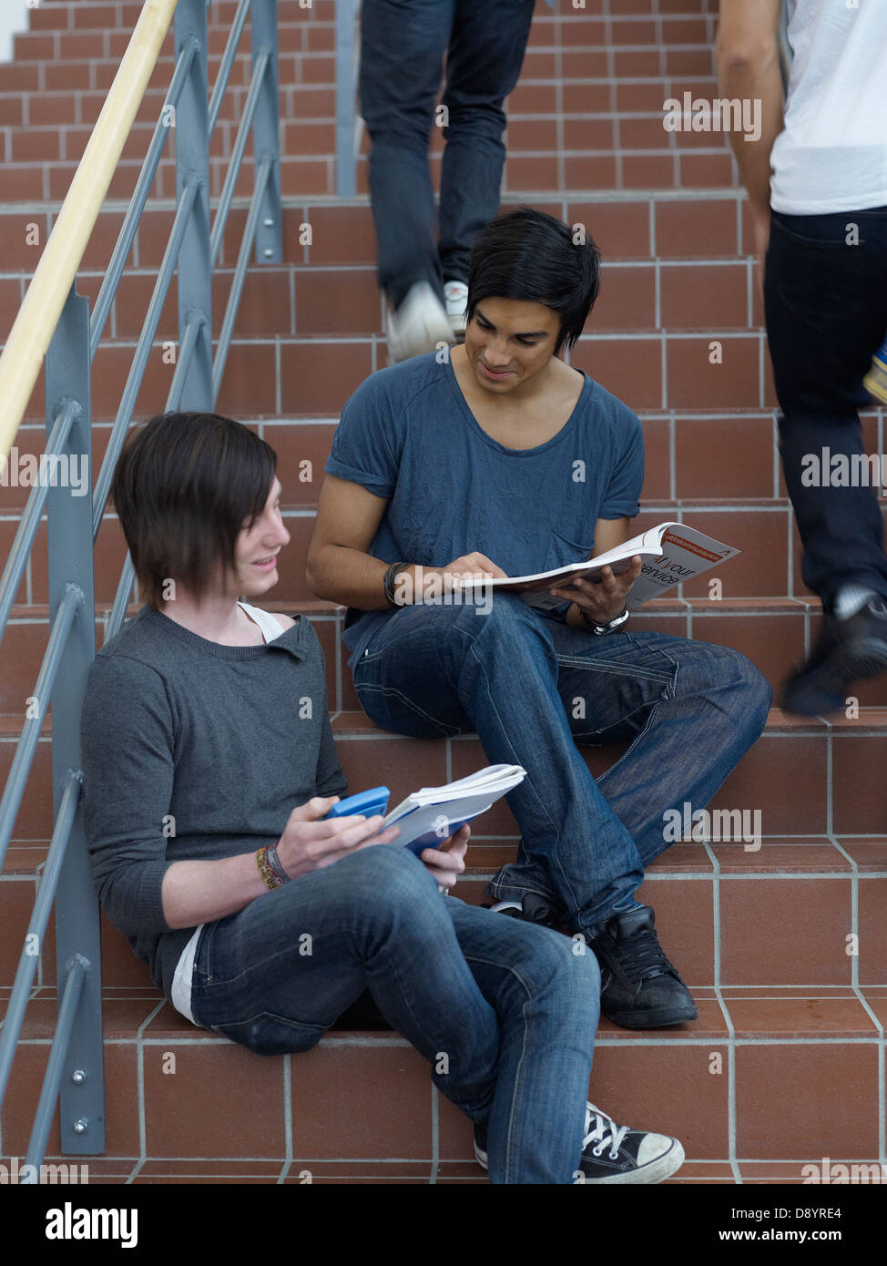 Two teenage boys sitting on steps Stock Photo - Alamy