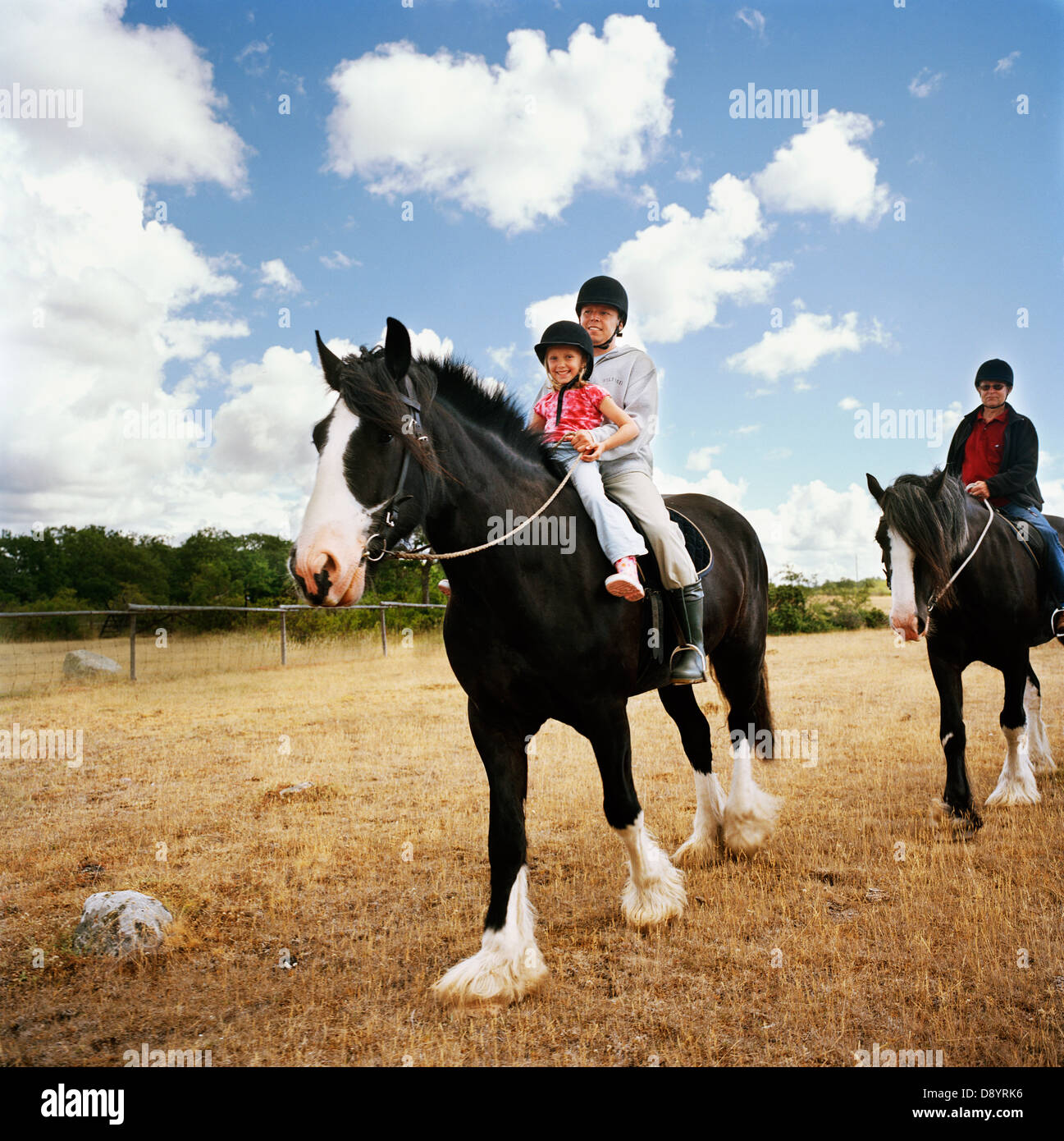Two children riding a horse Stock Photo - Alamy