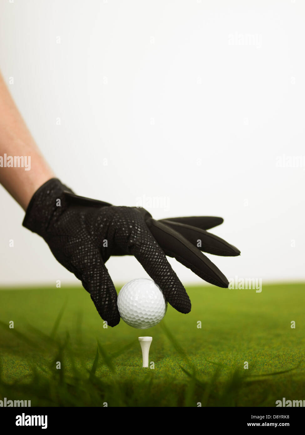Gloved hand holding golf ball Stock Photo - Alamy