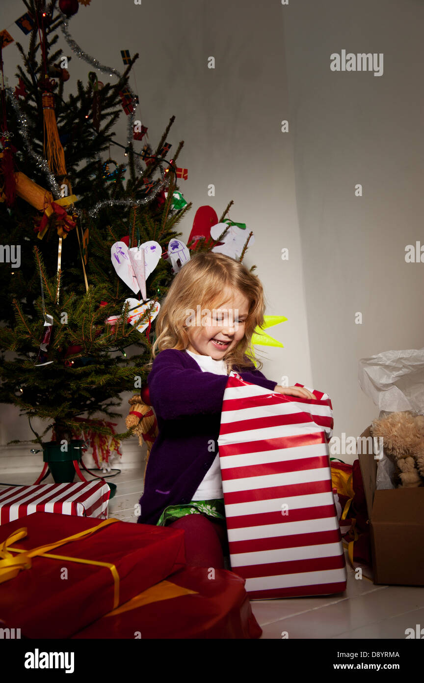 Girl opening gift, smiling Stock Photo - Alamy