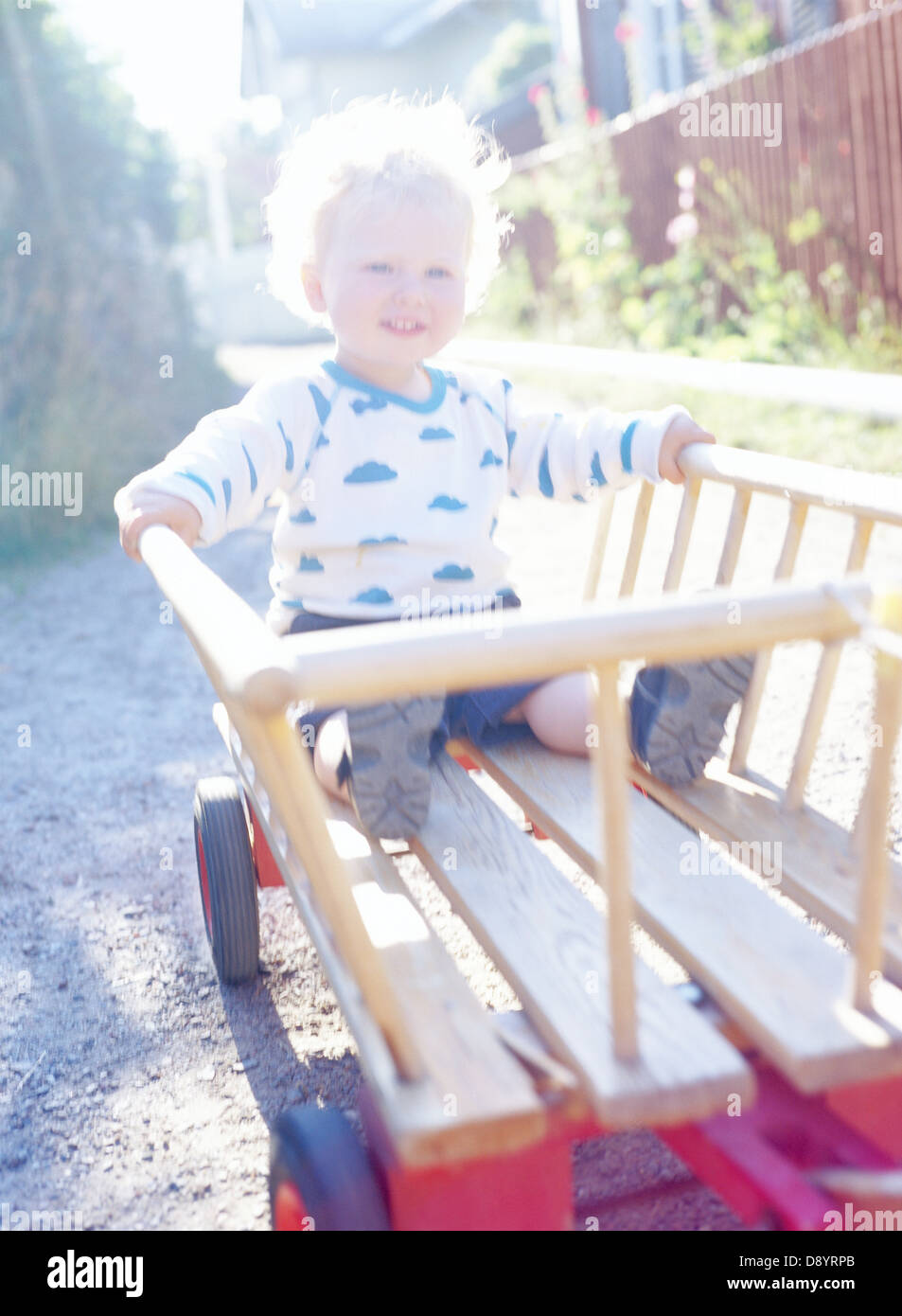 A smiling child in a wagon Stock Photo - Alamy