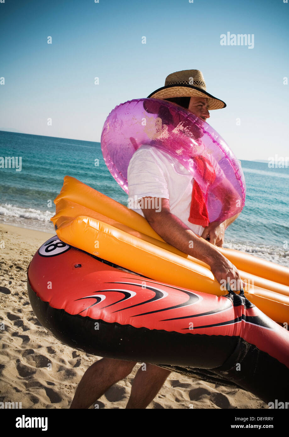 A man with water toys Stock Photo - Alamy