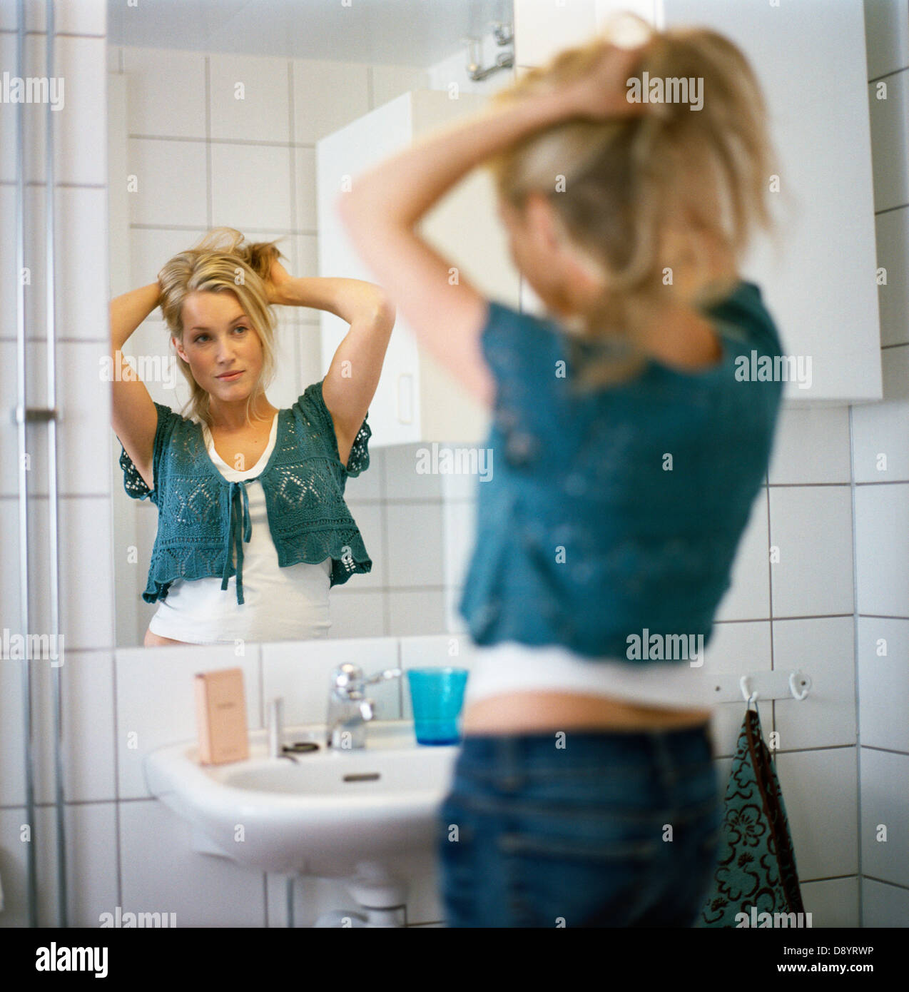 A woman fixing her hair Stock Photo - Alamy
