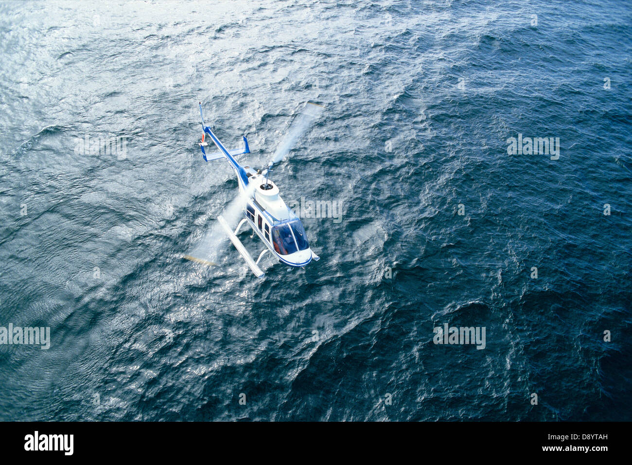 A helicopter over the sea Stock Photo - Alamy