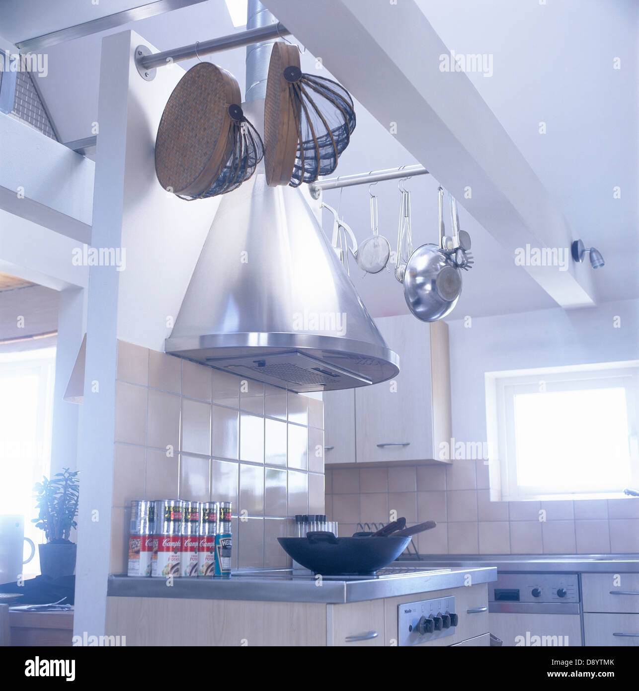 Fen over a stove in a designed kitchen Stock Photo - Alamy