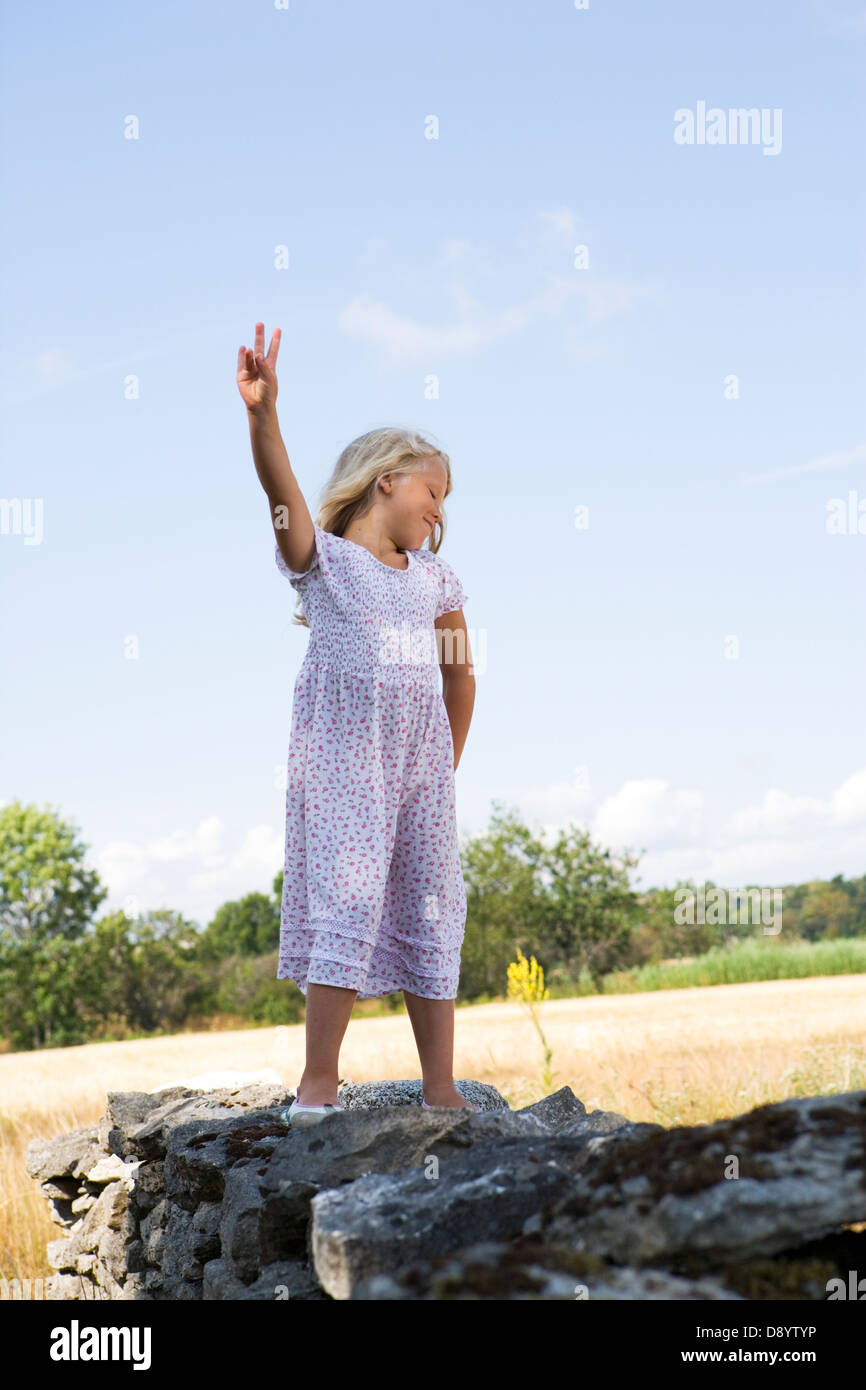 A girl on a stone wall Stock Photo - Alamy