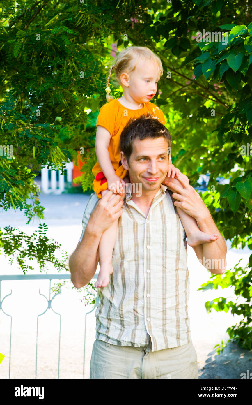 A father carrying his daughter on his shoulders Stock Photo - Alamy