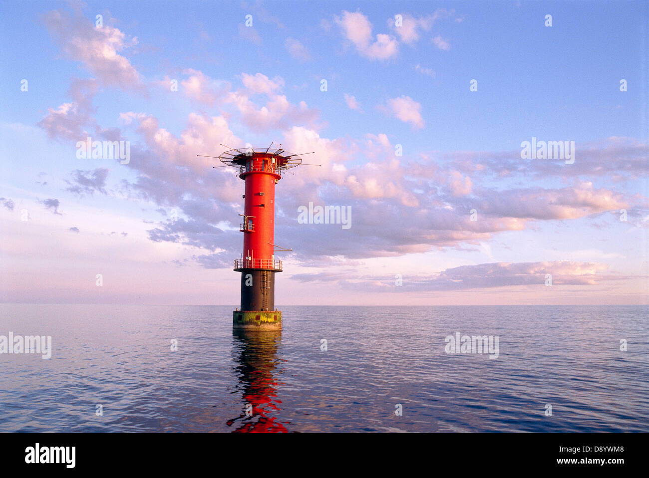 A lighthouse in a calm sea Stock Photo - Alamy