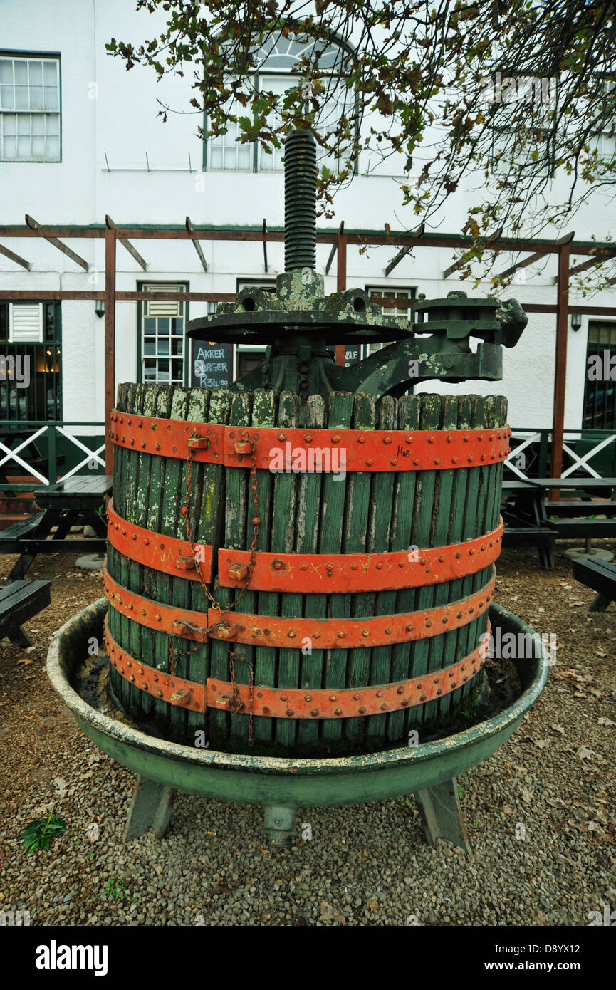 View of old wine press obsolete winery machinery in front of tavern ...