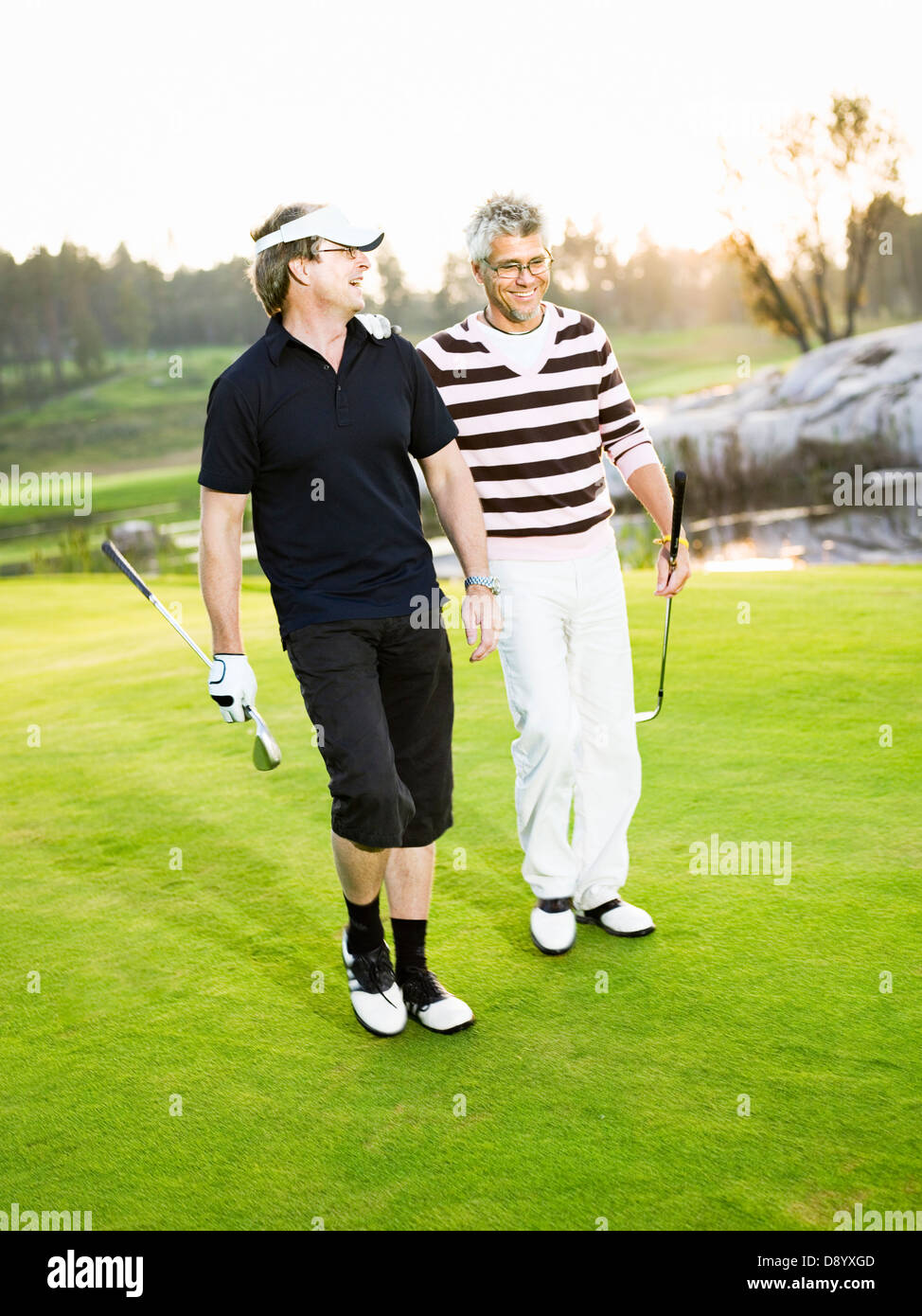Two men playing golf Stock Photo - Alamy