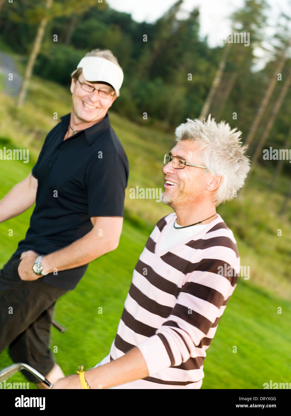 Two men playing golf Stock Photo - Alamy