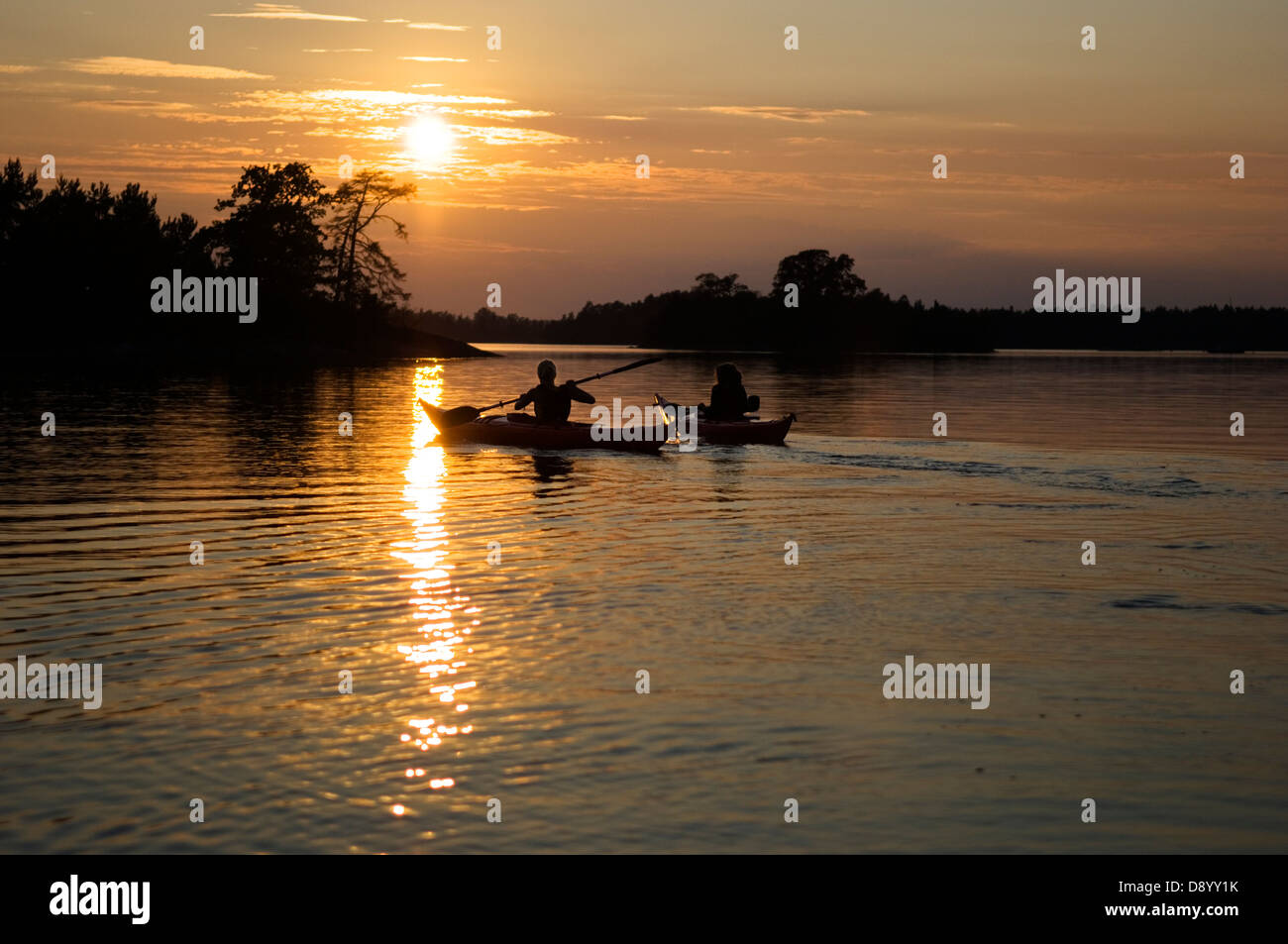 Paddling kayak in the sunset Stock Photo - Alamy