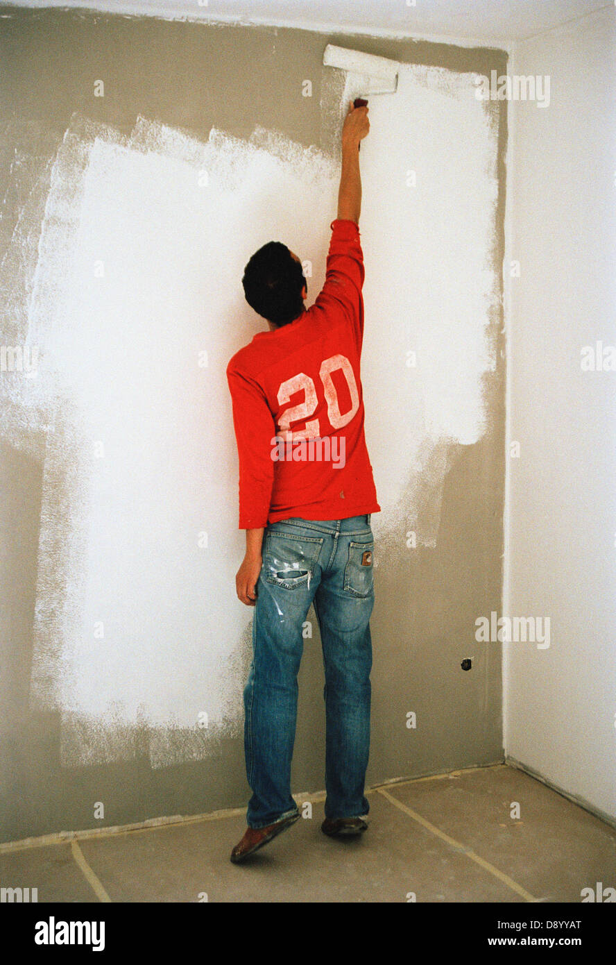A man painting a wall Stock Photo - Alamy
