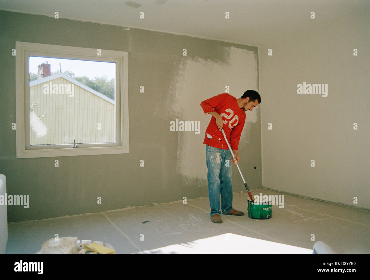 Man painting a wall Stock Photo - Alamy