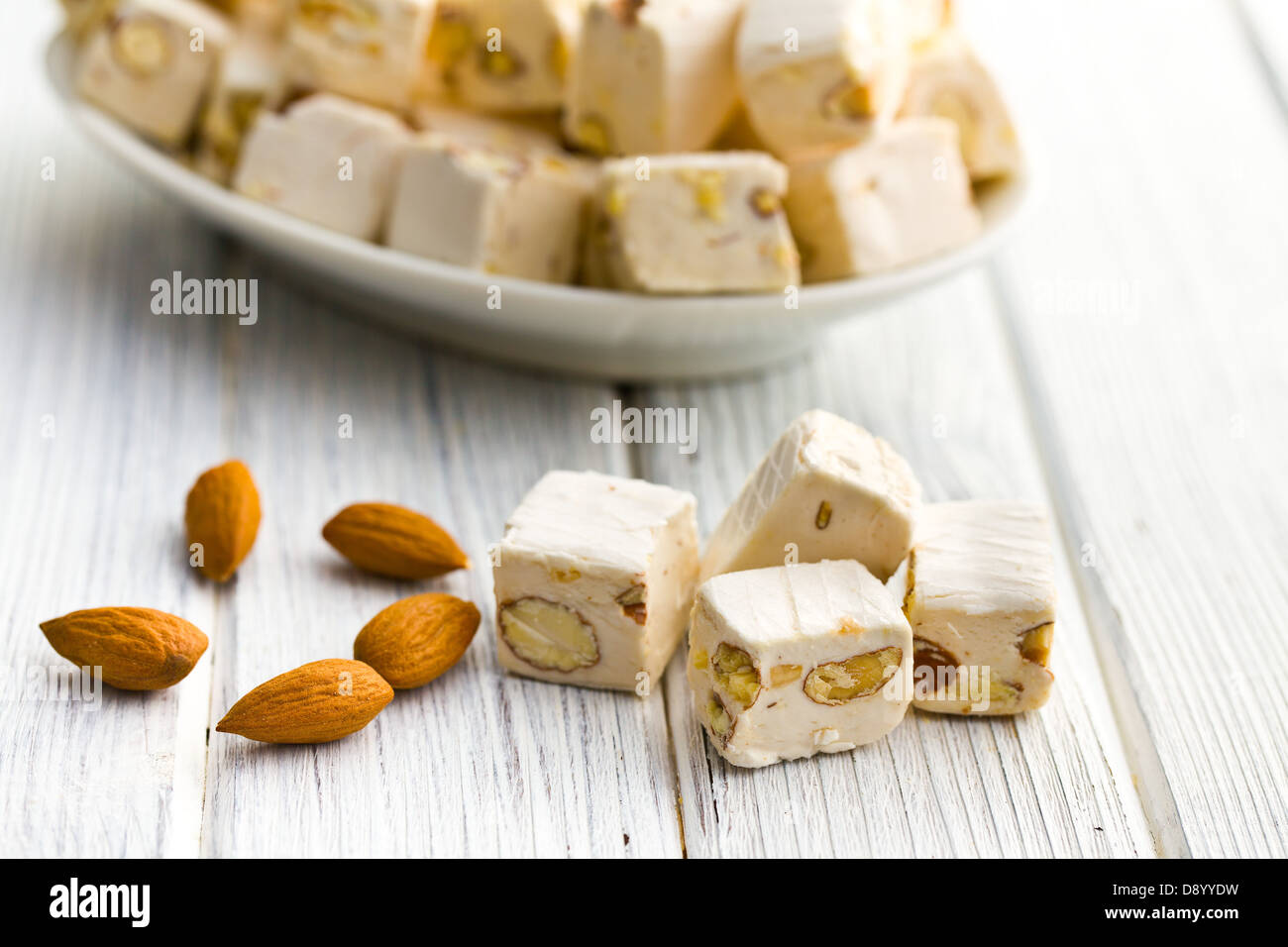 white nougat with almonds on wooden table Stock Photo - Alamy