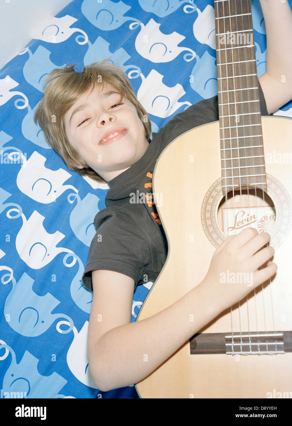 A boy playing his guitar Stock Photo - Alamy