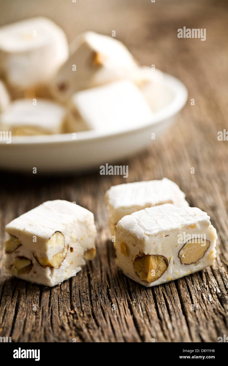 white nougat with almonds on wooden table Stock Photo - Alamy