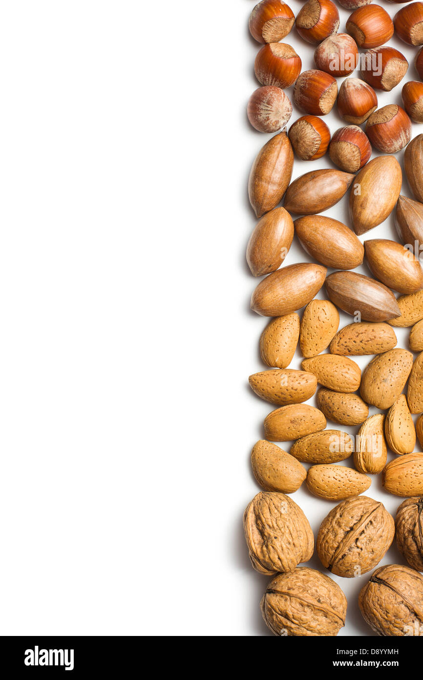 various unpeeled nuts on white background Stock Photo - Alamy