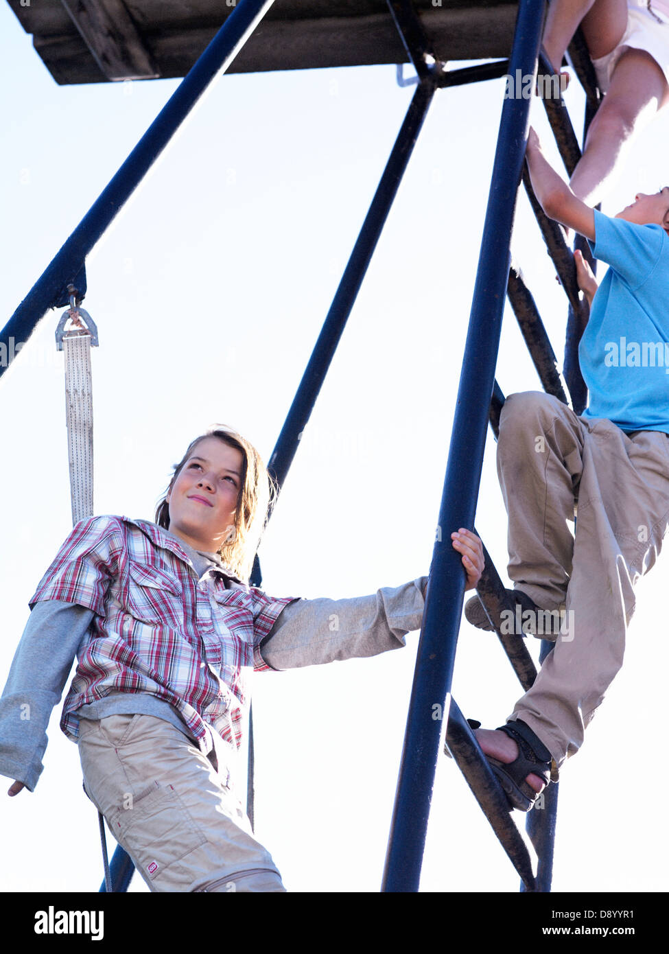 Three children climbing a diving tower Stock Photo - Alamy