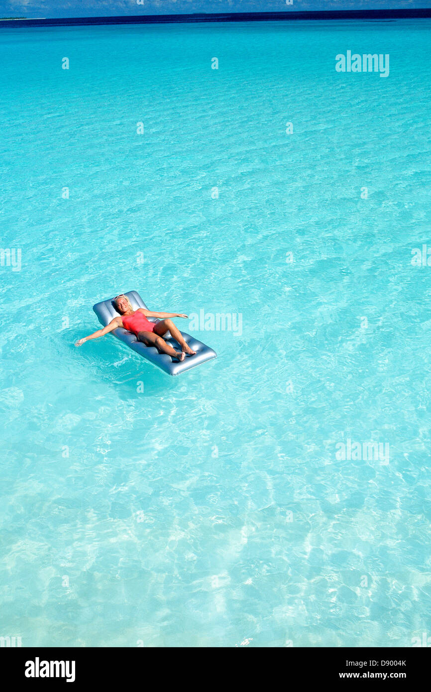A woman floating on inflatable in sea Stock Photo - Alamy