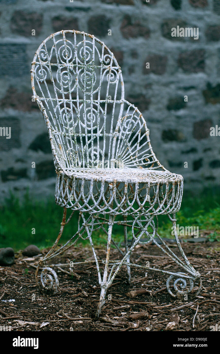 A rusty outdoor chair by a wall Stock Photo - Alamy