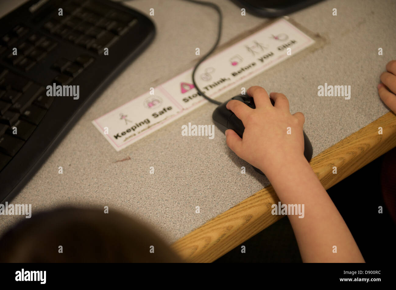 A child's hand holding a mouse operating a PC Stock Photo - Alamy