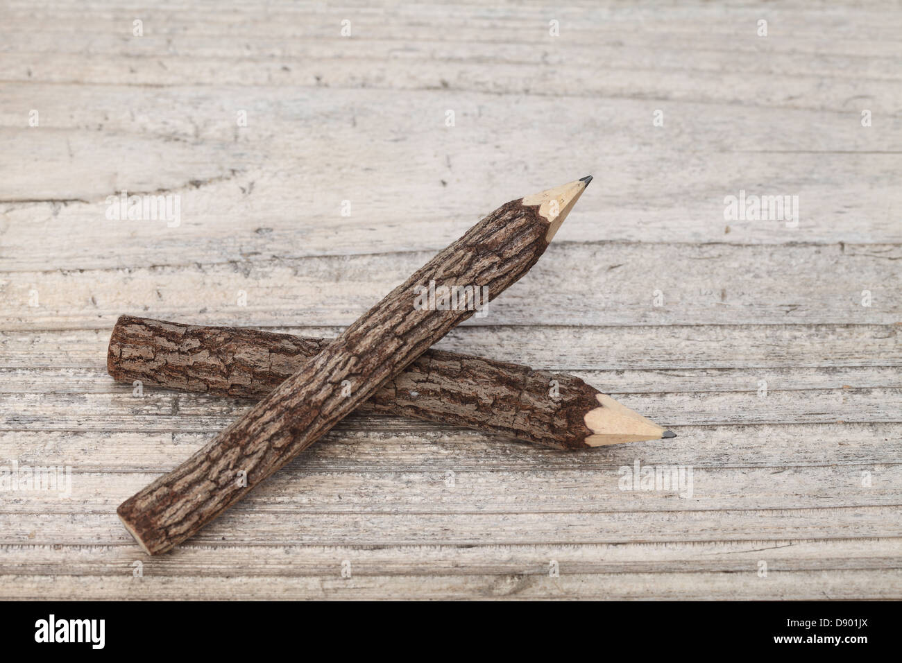Tree trunk pencils on wooden background Stock Photo - Alamy