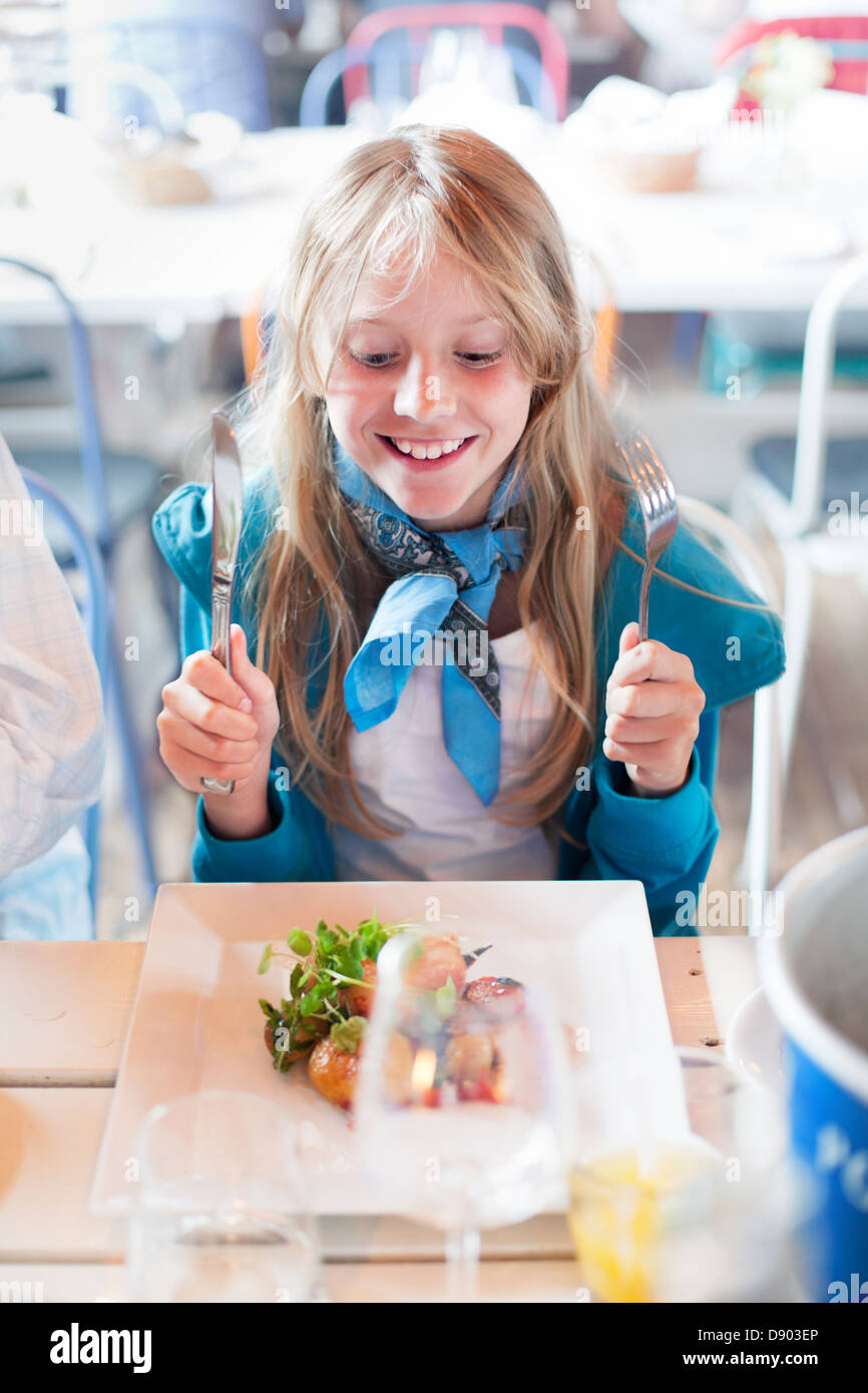 Smiling girl in restaurant Stock Photo - Alamy