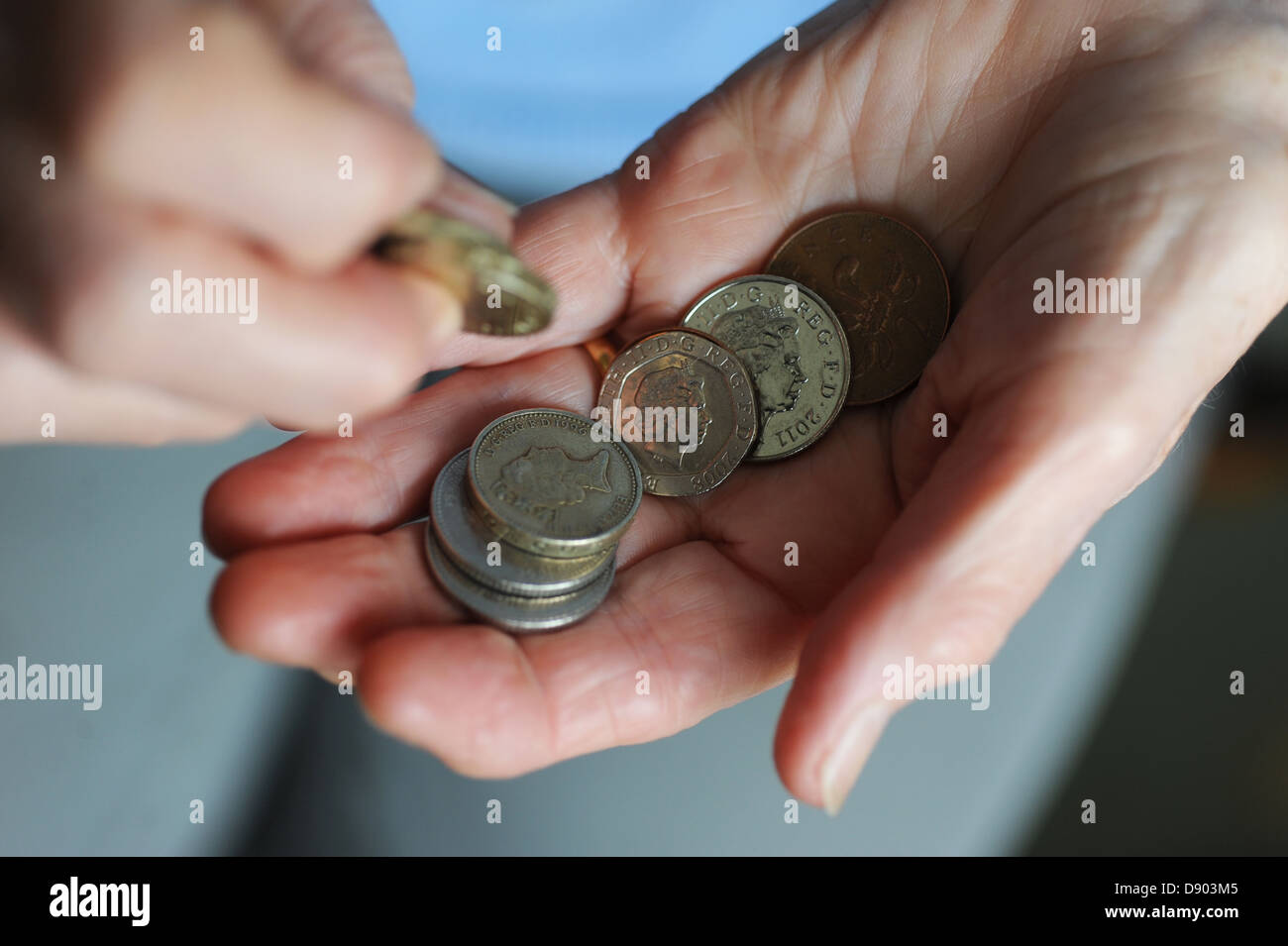Elderly caucasian woman sorting out her money Stock Photo - Alamy