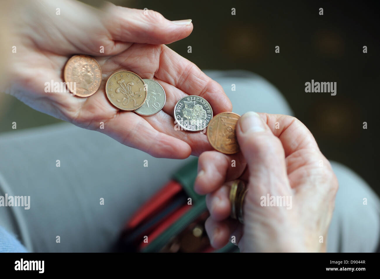 Elderly caucasian woman sorting out her money Stock Photo - Alamy