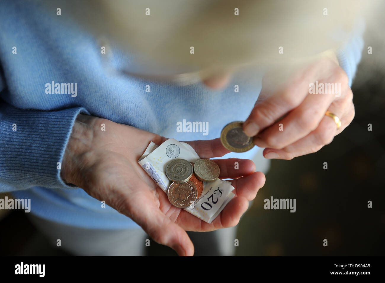 Elderly caucasian woman sorting out her money Stock Photo - Alamy