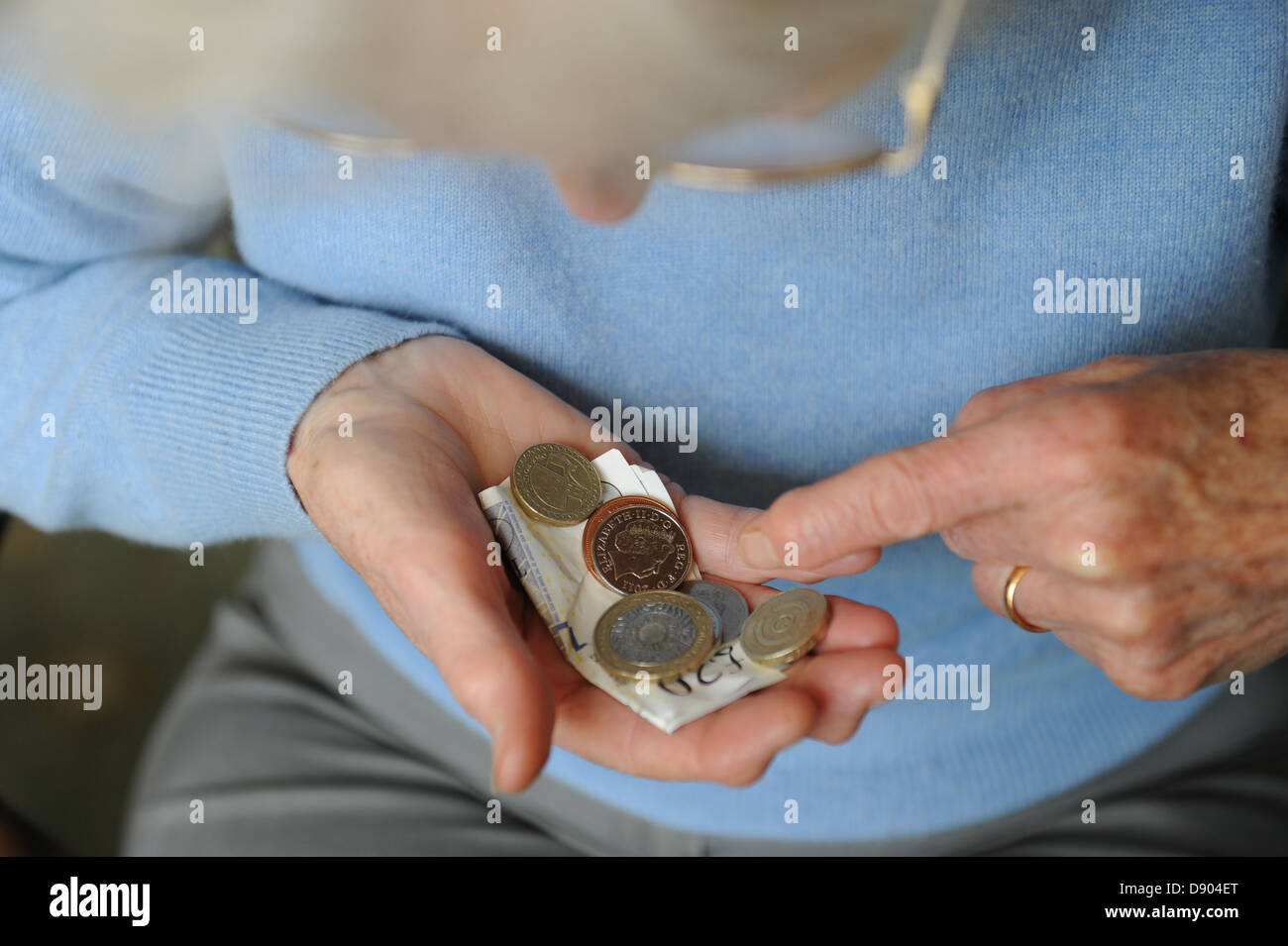 Elderly caucasian woman sorting out her money Stock Photo - Alamy