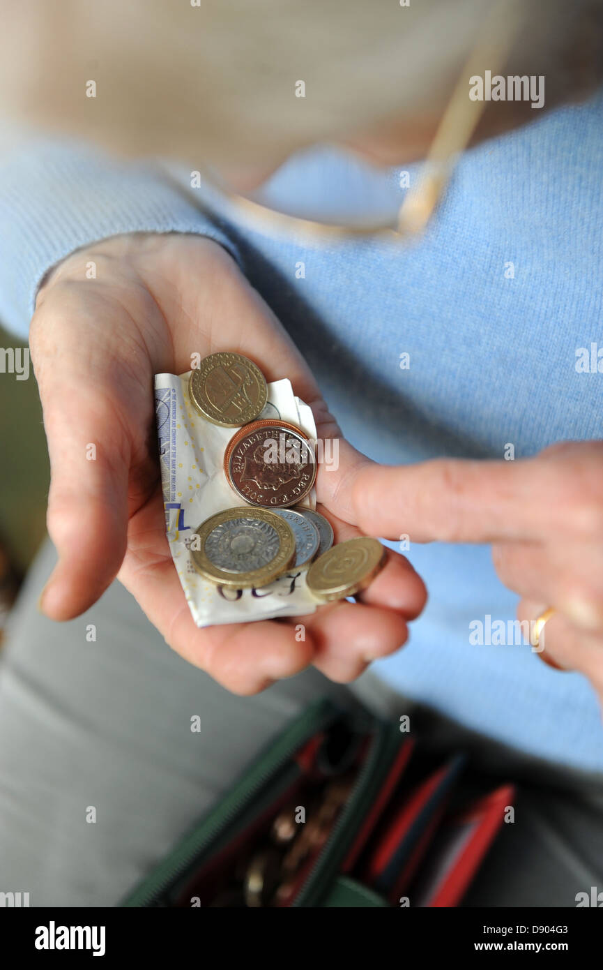 Elderly caucasian woman sorting out her money Stock Photo - Alamy
