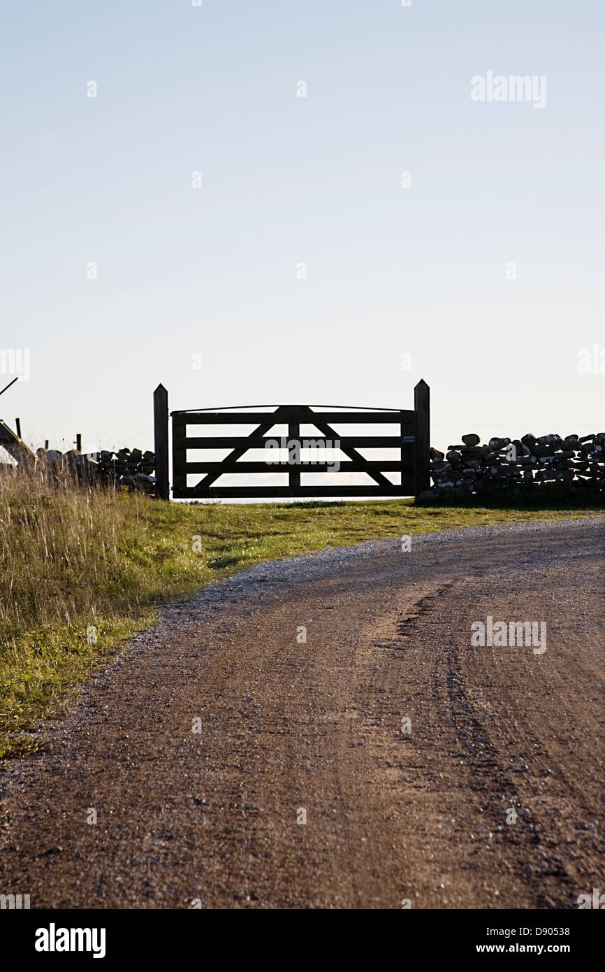 Gate at a gravel road Stock Photo - Alamy