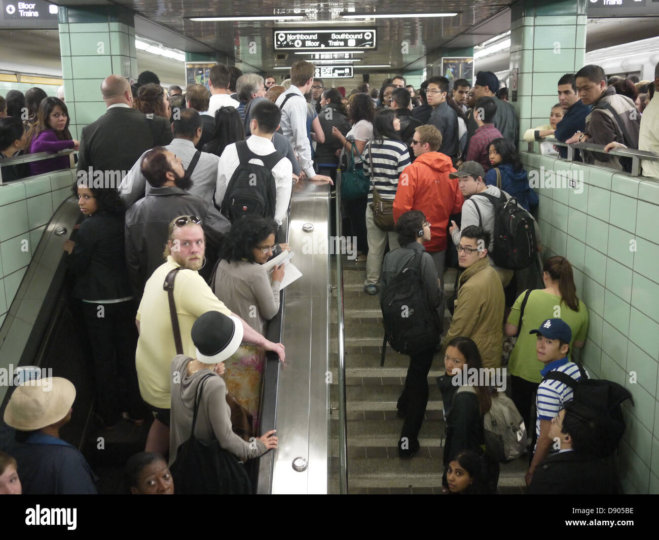 overload escalator crowd long lineup Stock Photo - Alamy