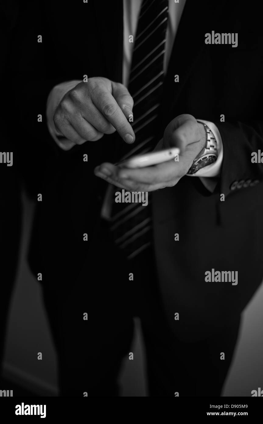 Man holding smartphone one Black and White Stock Photos & Images - Alamy